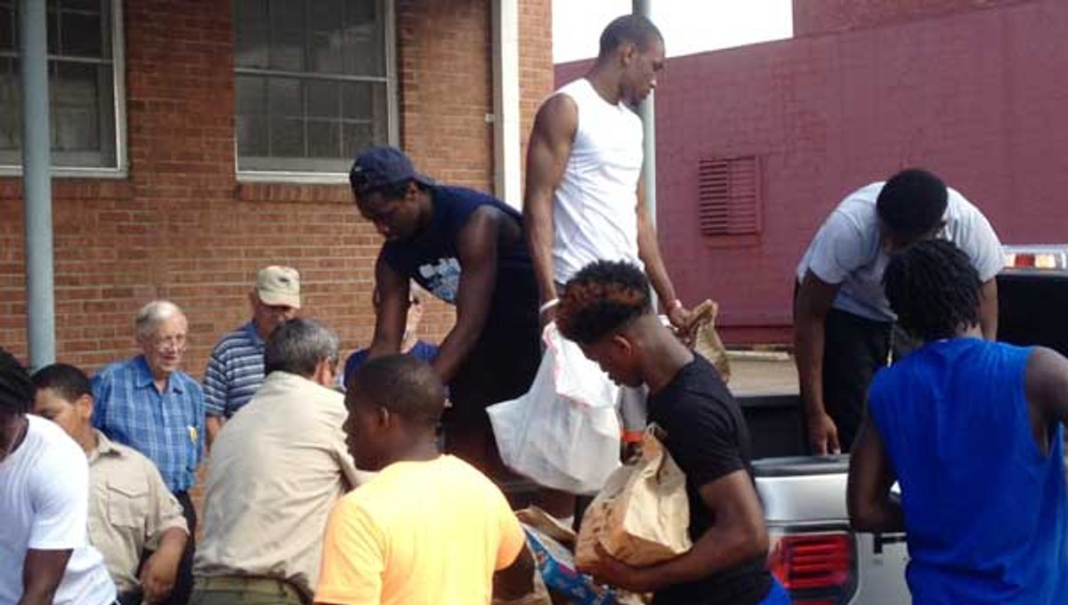 Natchez High football team lend stewpot a helping hand