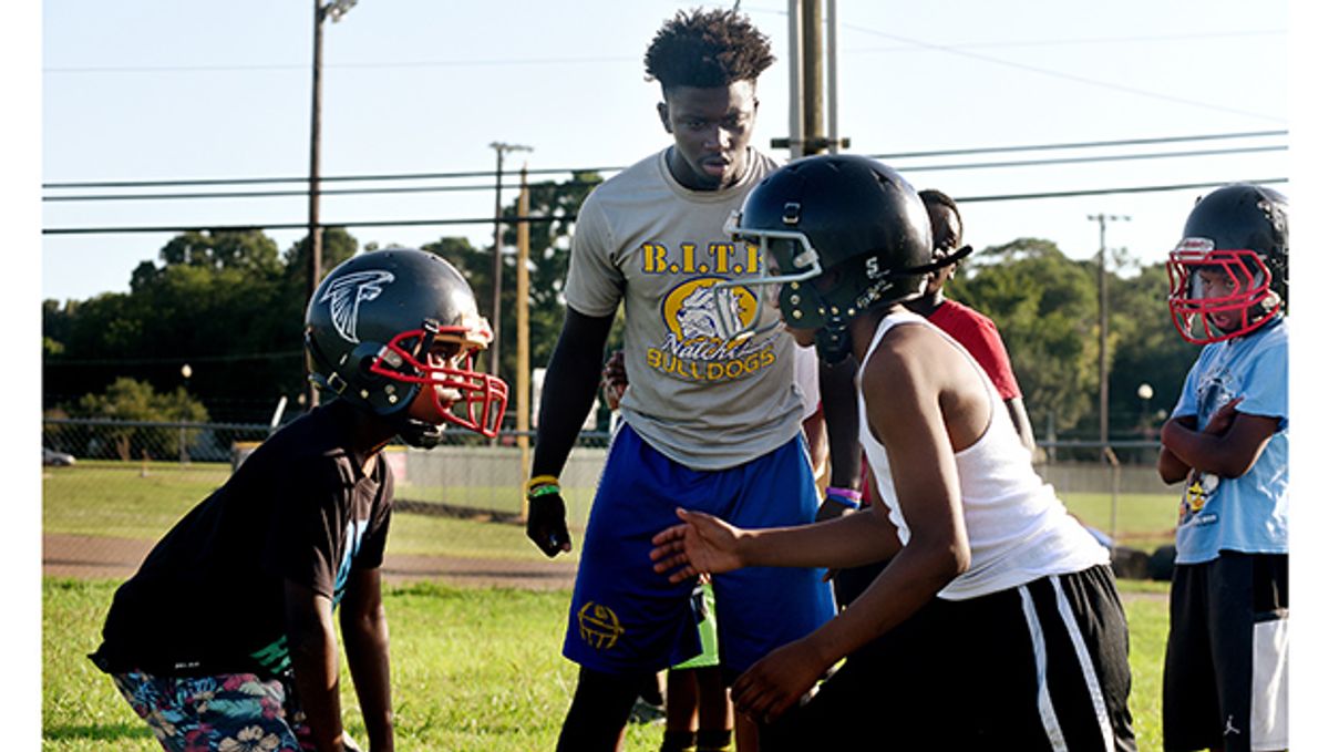 Natchez High players help coach youth football team