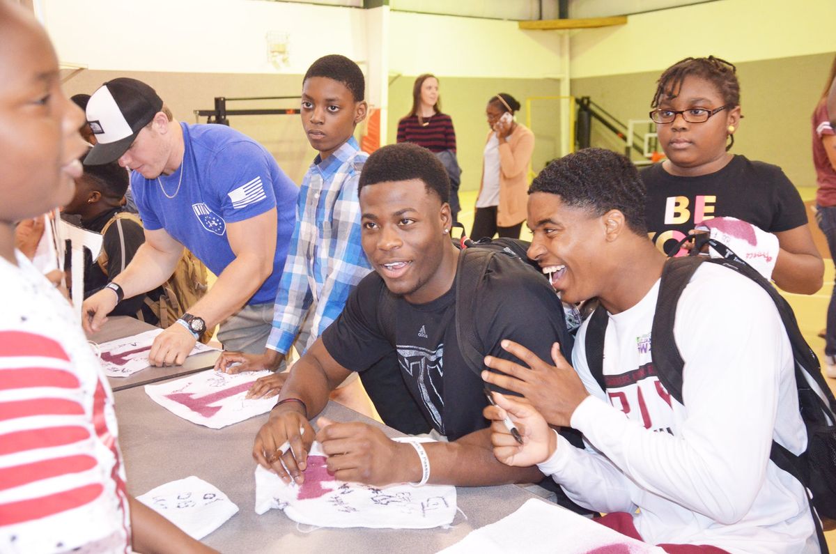 WORDS OF WISDOM: Troy football players encourage local kids