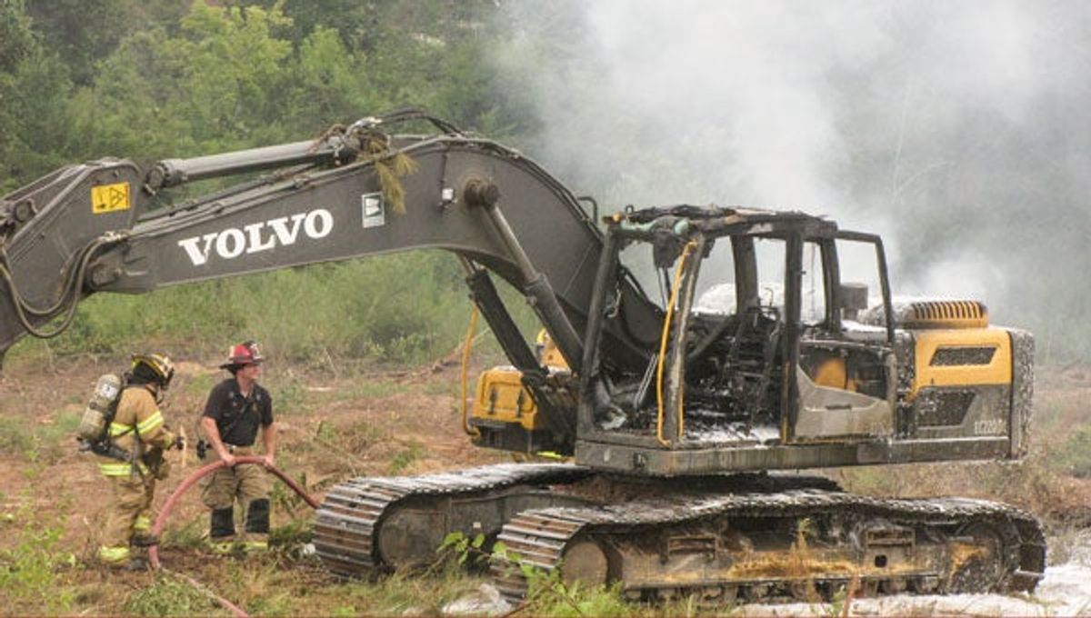 Excavator catches fire while clearing land