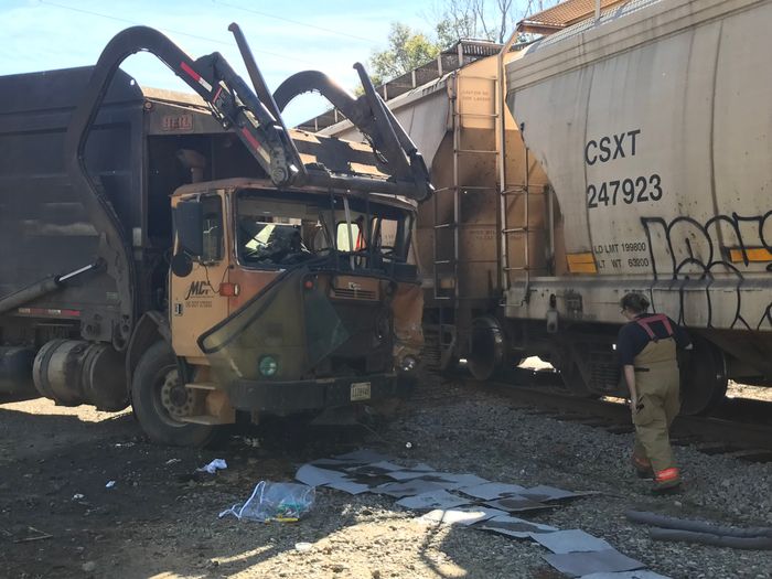 Train collides with garbage truck