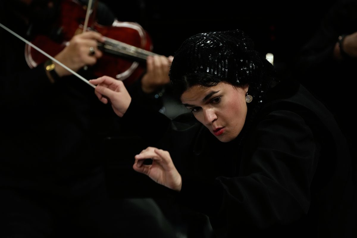 Photos of the first female conductor to lead a Tehran Symphony Orchest...