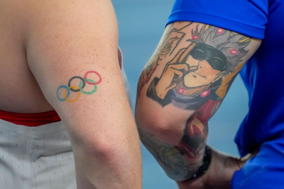 AP PHOTOS: Athletes showcase tattoos of Olympic rings, lions and super...