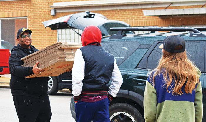 Despite rain and cold, community rallies for food drive to help famili...