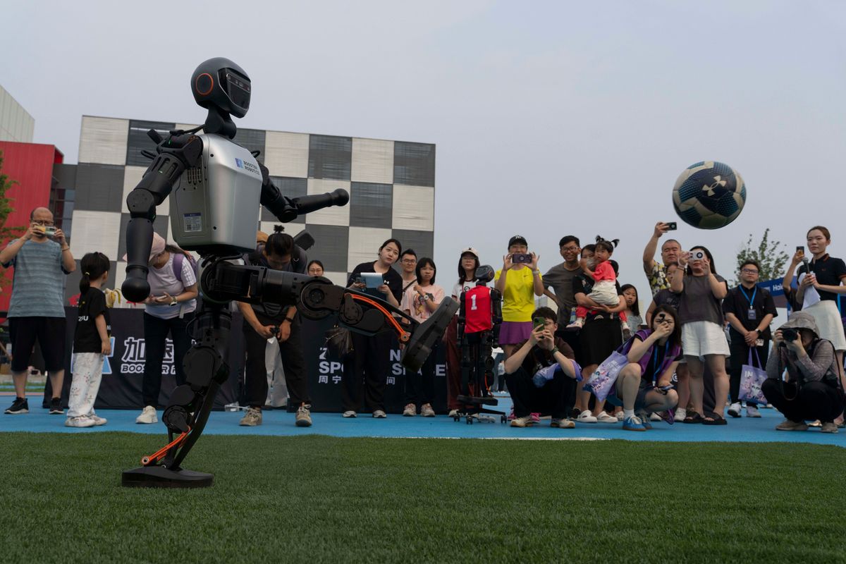 Photos show how humanoid robots captivate fans in China by playing a s...