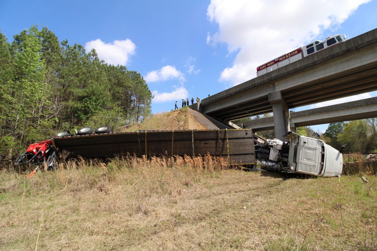 Truck careens down highway embankment
