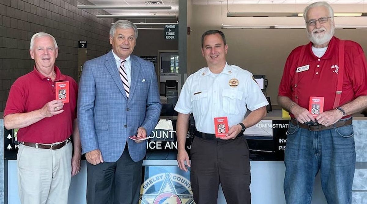 UA Alumni Chapter donates football guides to first responders