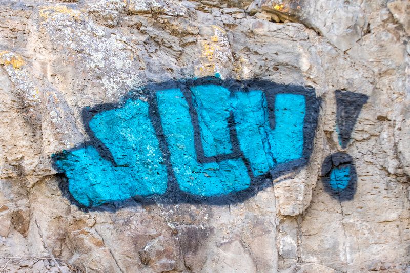 Graffiti mars river’s canyon wall
