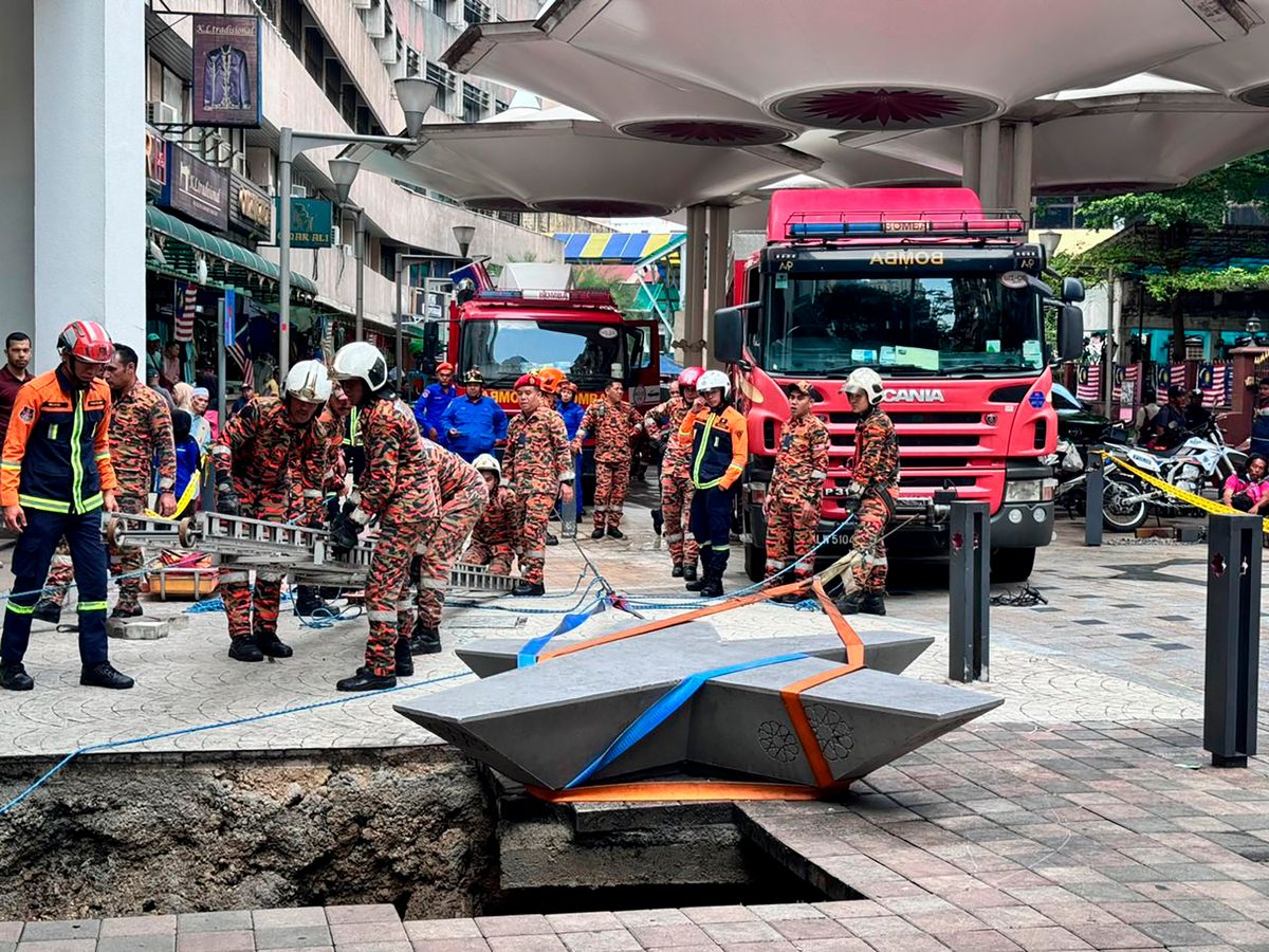 Woman plunges into 8-meter deep hole after pavement sinks in...