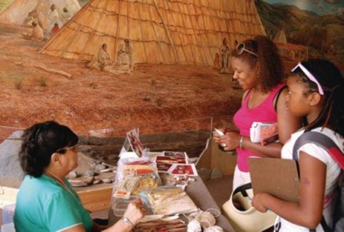 Nez Perce woman demonstrates tribal crafts to visitors