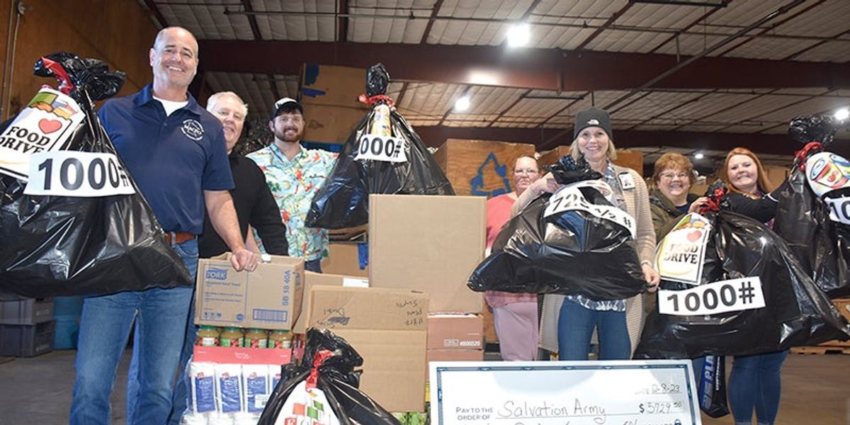 County wins Food Drive Competition over the City with check donation