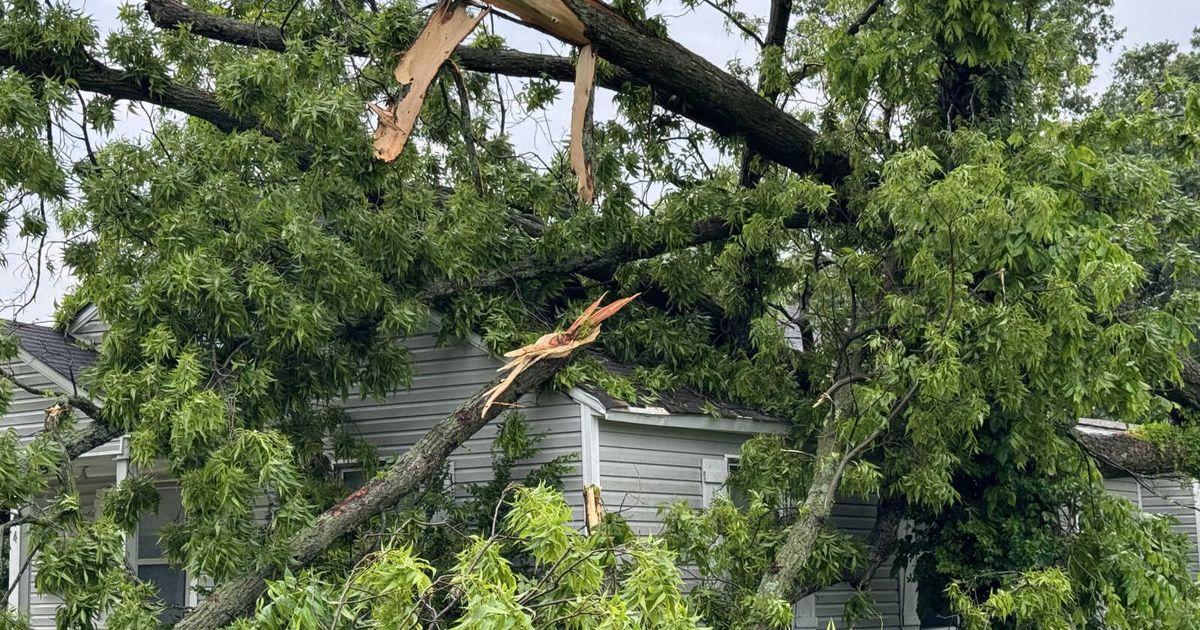 Building damage and widespread power outages follow storm