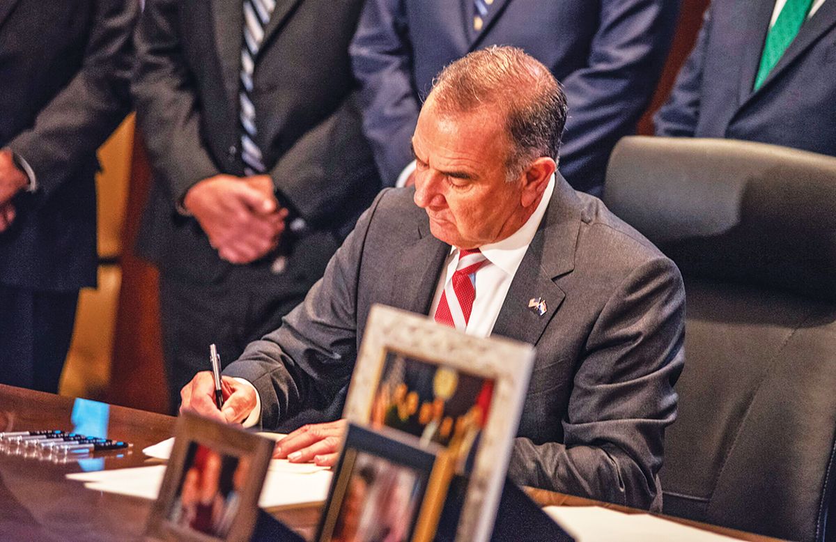Gov. Mike Kehoe signs his first executive orders following his inaugur...