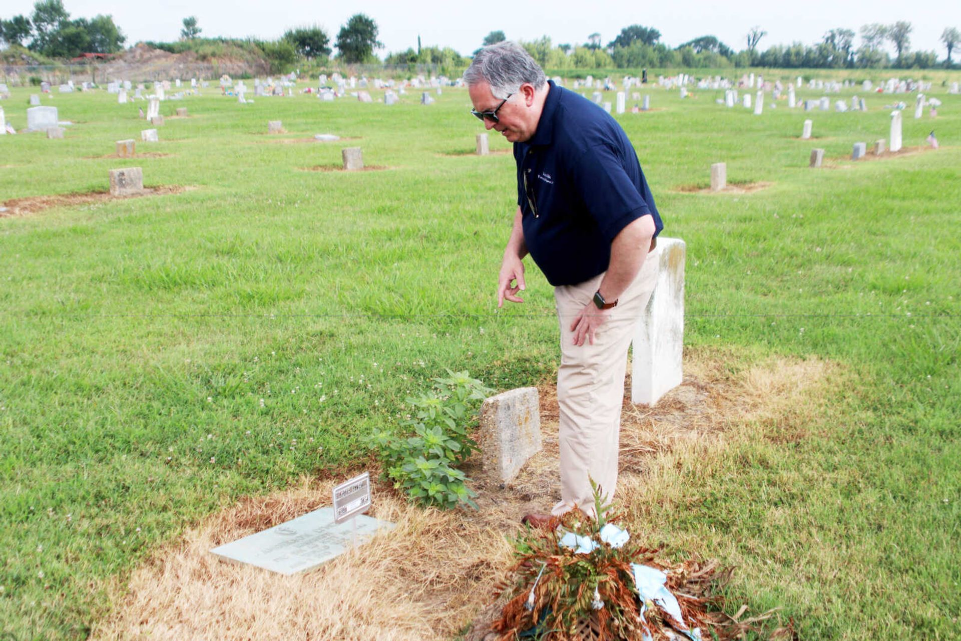 Funeral home director reunites father, son after grave sunk into the g...