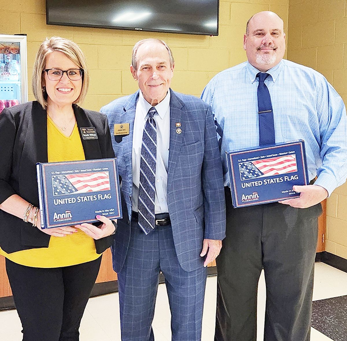 Representative Johnny Rye presents flags to Trumann High School leader...