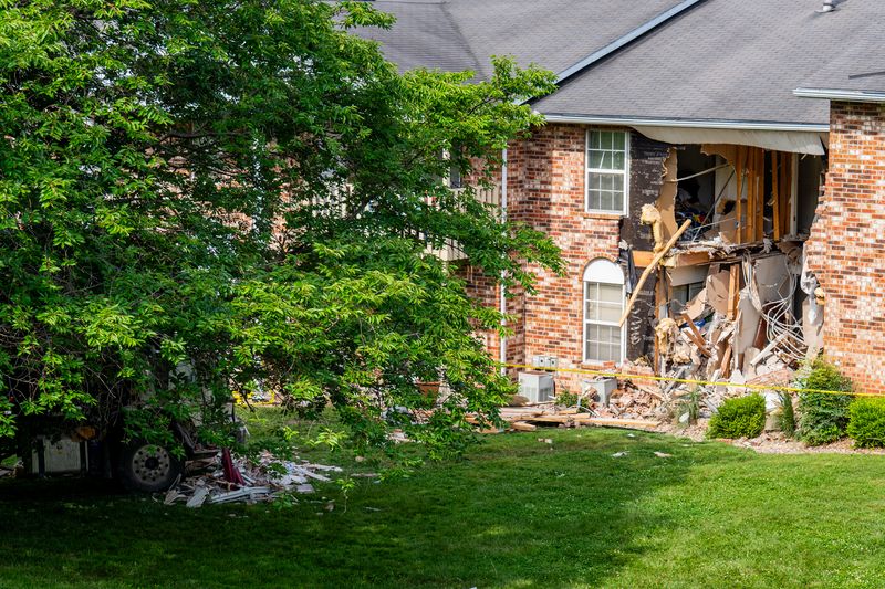 Trash truck crashes into apartment; driver dies