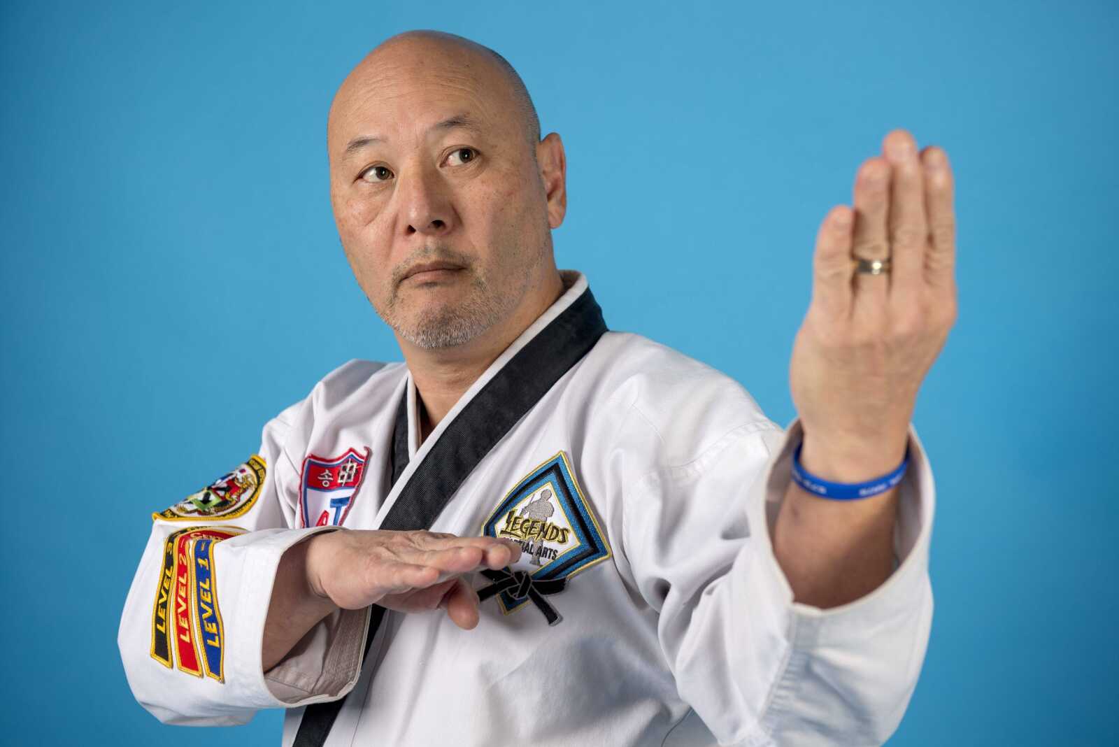 Still kicking': John Johnson and son use taekwondo to help students bu...