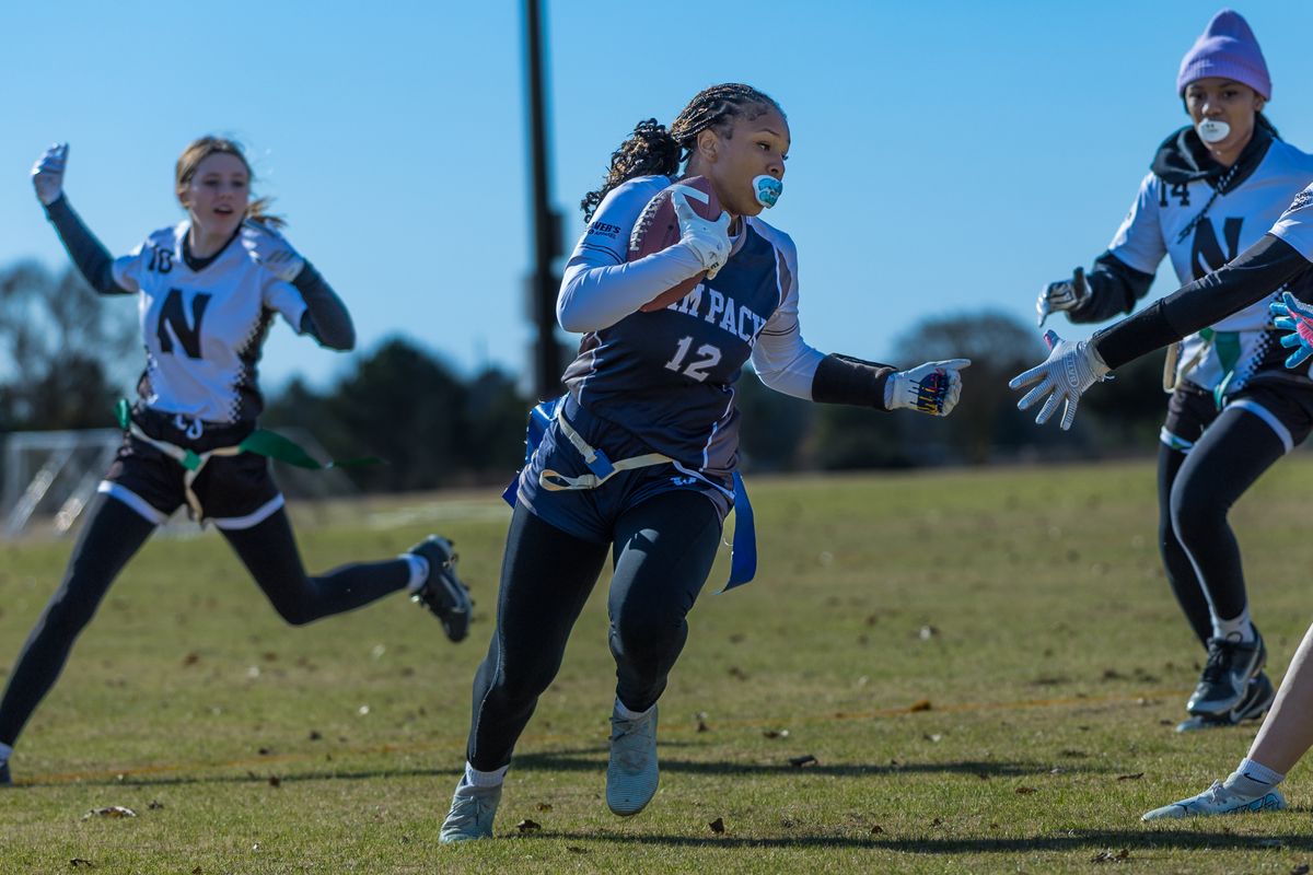 One final run: Northside, Washington, Southside take part in flag foot...