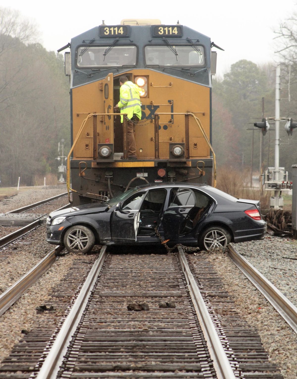 Woman escapes car before train hits