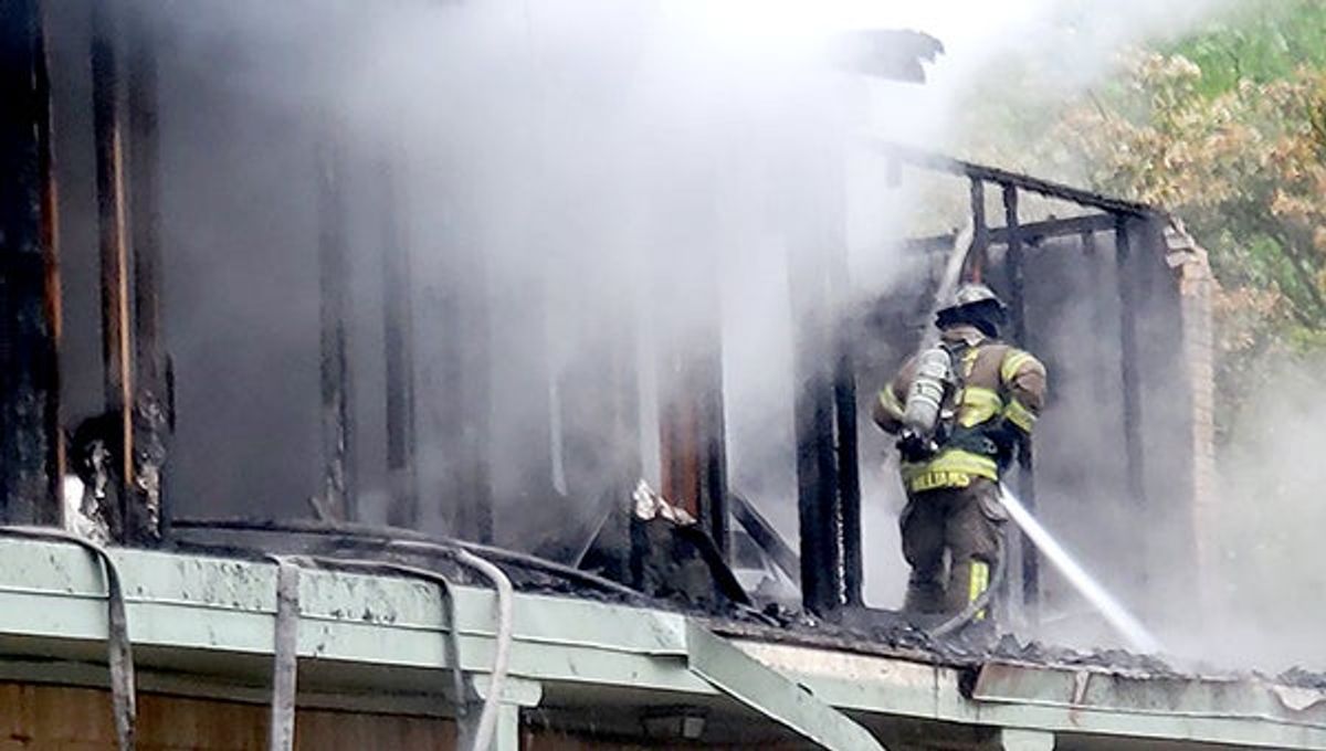 Officials: Knocked over candle ignites morning apartment fire